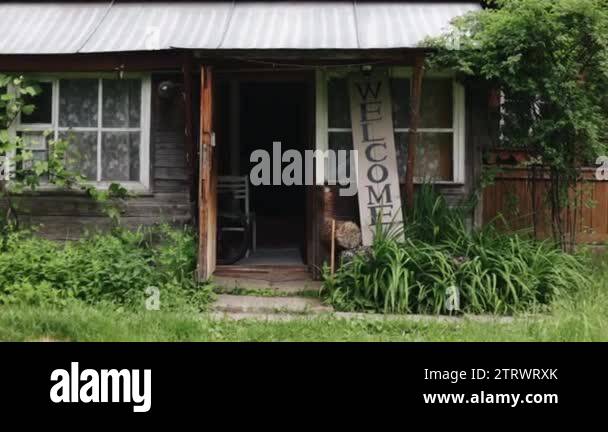 A young smiling man with two empty buckets walking out of the small ...