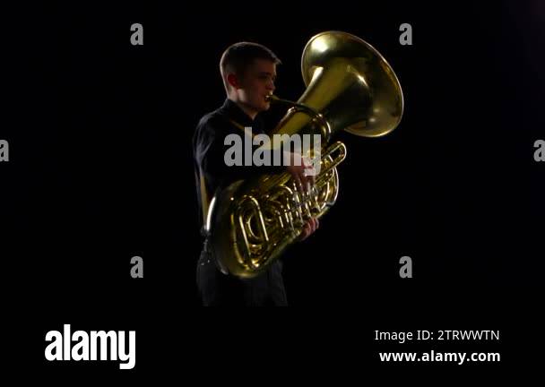 Man plays on the tuba slow melody. Black studio background Stock Video ...