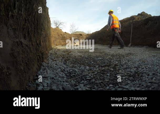 Man serving compacting machine. Stone compaction during the ...