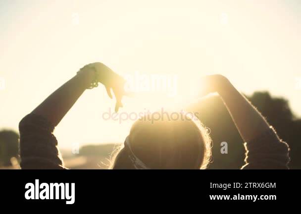 Womans hand in the sunlight. Waving hand over the sun. girl reaches out ...