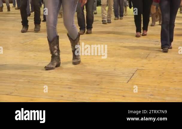 Woman legs dancing cowboy line dance at a folk country event, USA style ...