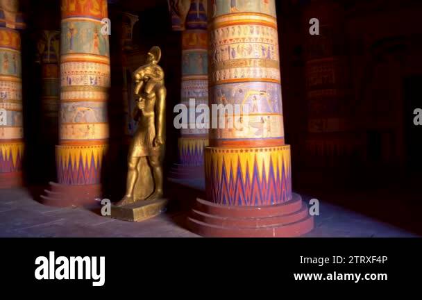 Egyptian palace filled with colourful columns and a statue of Khnum ...