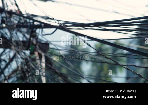 Tangled bundles of overhead wires. Electricity system on the streets of ...