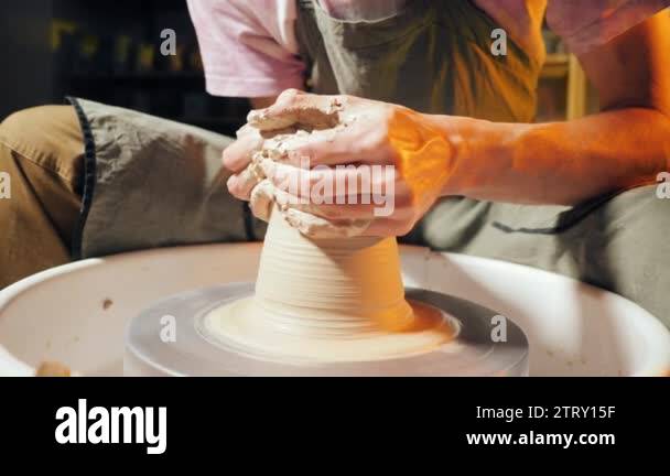 Traditional pottery making, man teacher shows the basics of pottery in ...