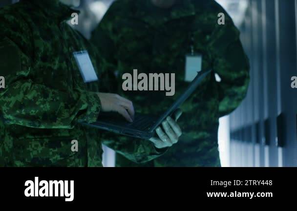 In Data Center Two Military Men Work with Open Server Rack Cabinet. One ...