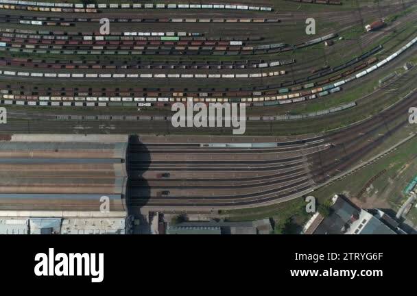 Train station with freight trains and containers in aerial view. Aerial ...