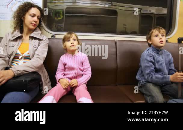 Mother with little daughter and son sit in riding subway train Stock ...