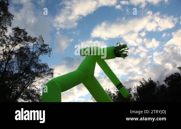 Inflated man dance at background of sky with clouds on City Day Stock ...