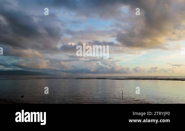 A cloudy sunrise video from Dumaguete City shores, Negros Oriental, Philippines. Cebu Island can ...