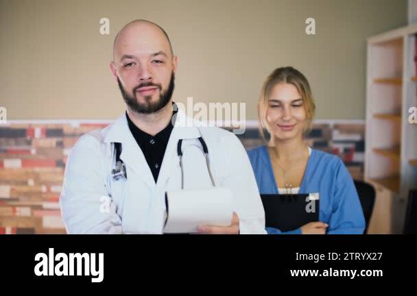 Adult 30s male doctor man with a 20s female nurse in uniform are posing ...