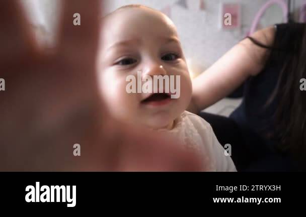 Cute baby laughing is touching the lens of video camera Stock Video ...