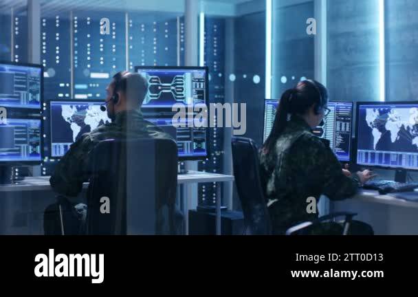 Male and Female Military IT Technicians Working on Computers with ...