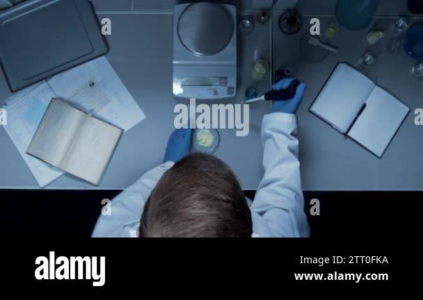 Laboratory technician injecting liquid into a microtiter plate. the ...