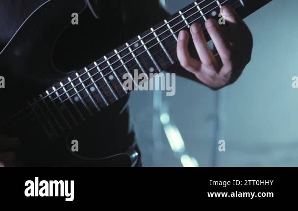 Close up of Guitarist playing the electric guitar on stage. Performance ...