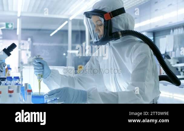 Medical Virology Research Scientist Works in a Hazmat Suit with Mask ...