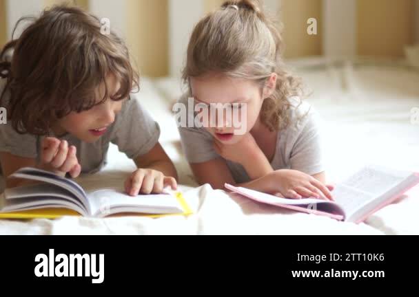 Brother and sister learn the lessons lying in bed Stock Video Footage ...