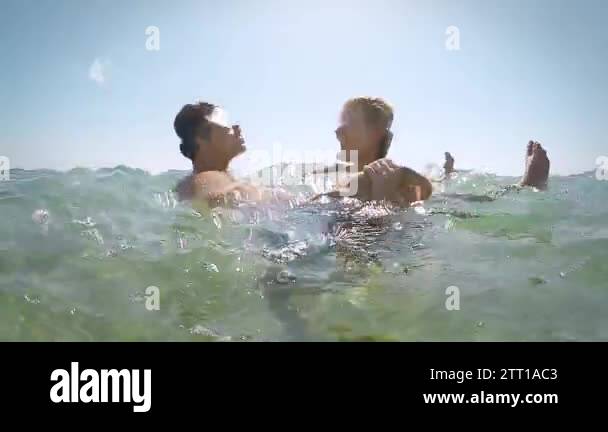 Romantic couple, pair on the beach, hug and kiss in the water. Slow motion capture., gopro dome ...