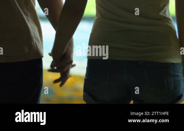 Romantic couple holding hands entering stadium before sports game ...