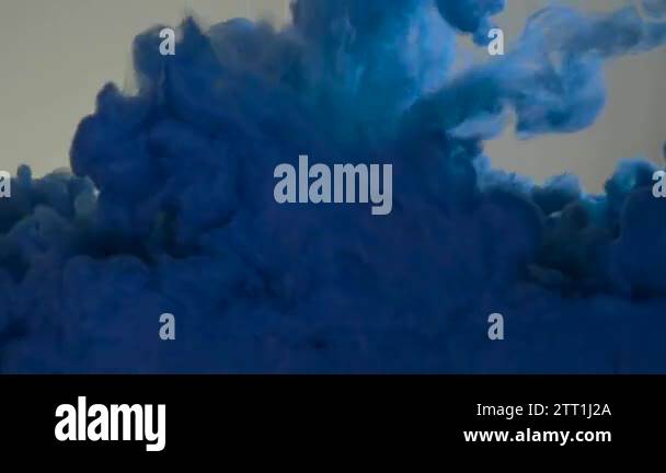Blue color paint pouring in water. Acrylic colors and ink in water ...