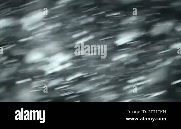 White nowflakes floating in the air on a black background.Ideal for ...