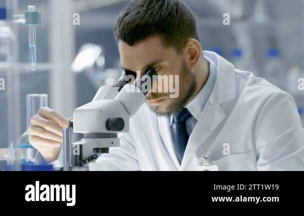Research Scientist Looks into Microscope. He's Working in a High-End ...