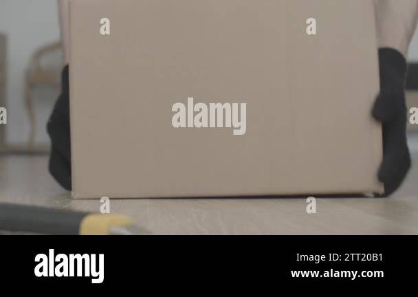 Cutting box on floor. Person buys new furniture elements for new home ...