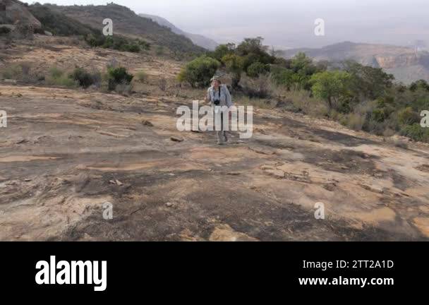Woman Hiking On A Stone Plateau On A Cooled Lava To The Top Of A ...