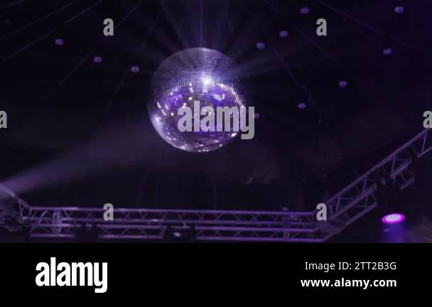 Mirror disco ball at the party. Rotates, reflecting the rays of light ...