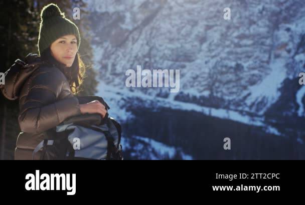 A girl rests and relaxes watching snowy mountains in front of him ...