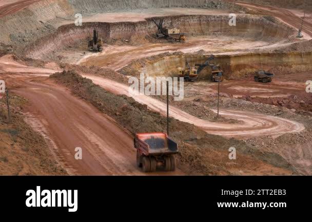 Excavators load ore into dump-trucks. This area has been mined for ...