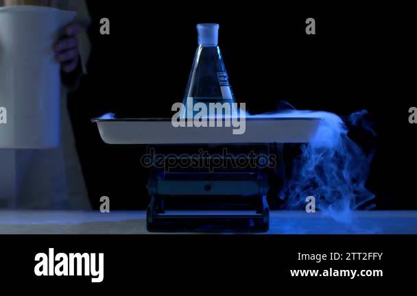 Bottle and liquid nitrogen in a laboratory. Chemical experiment. Flask ...