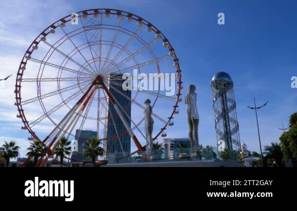 Statue of Ali and Nino and Ferris Wheel against the Alphabet Tower on ...