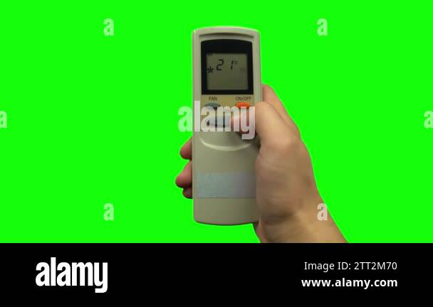 Hand pushing temperature button on air conditioner remote control ...
