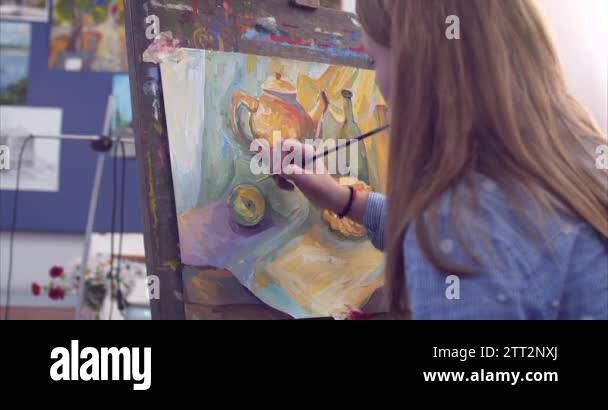 A Young Beautiful Female Artist is in an Art Studio, Sitting Behind an ...