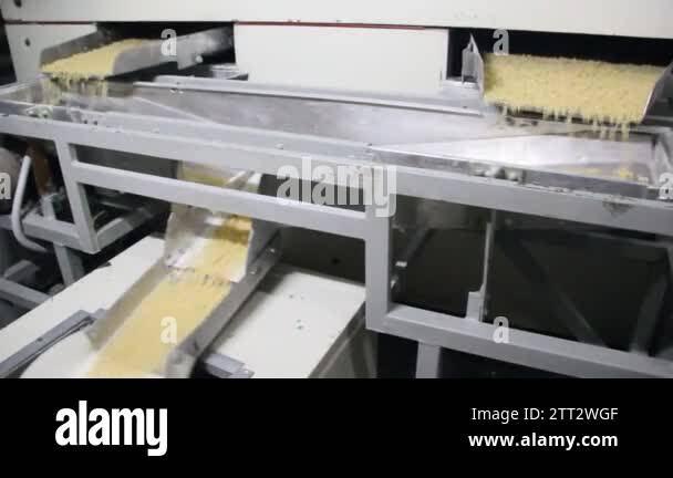 The production of pasta. The pasta piled on a conveyor belt Stock Video ...