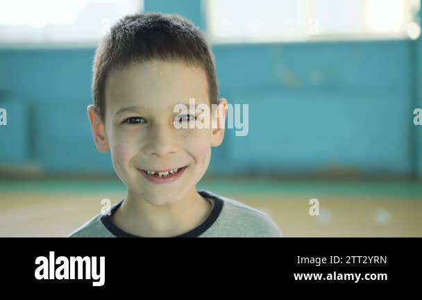Funny handsome boy looking back and laughing at camera in the gym 4K ...