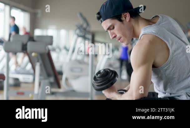 A shirtless guy at the gym, trains his body to stay fit and have ...