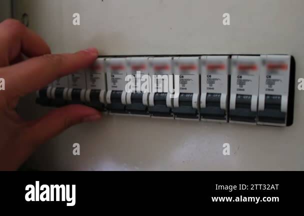 Female hand toggle switch in the switch box, All switches being turned ...