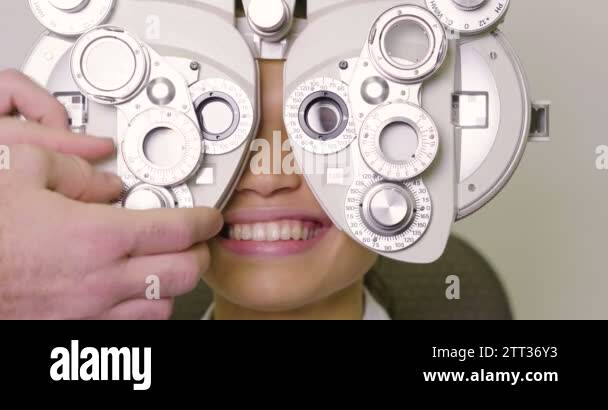 video of doctor checking woman eyes with phoropter ophthalmic testing ...