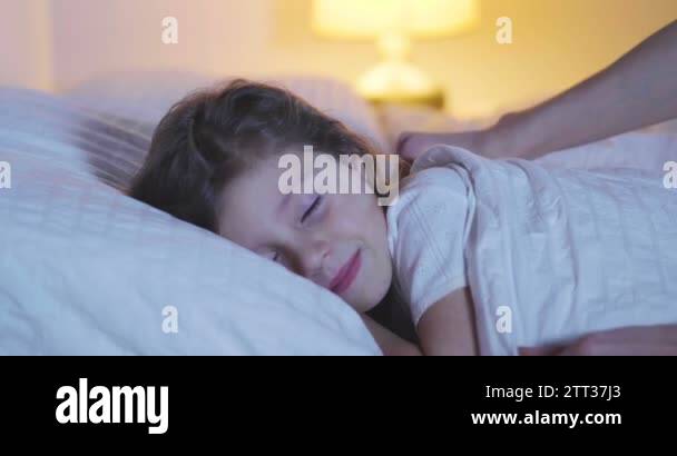 Goodnight mother to her little daughter who sleeps at night in her ...