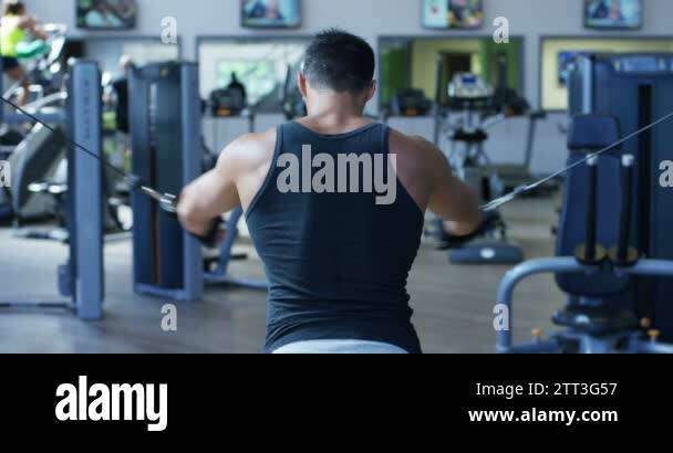 Guy bodybuilder in the gym, works with a barbell, bench press ...