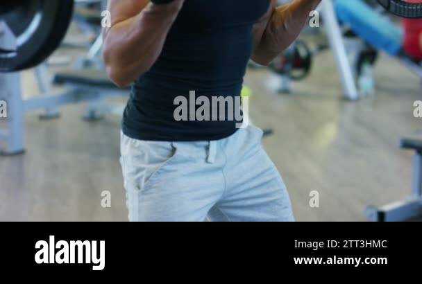 Guy bodybuilder in the gym, works with a barbell, bench press ...