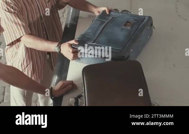 Colombian gangster in a white shirt in the style of the 80s stands near ...