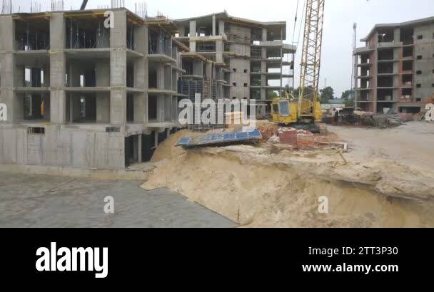 Flight above the construction site of the concrete frame of a multi ...