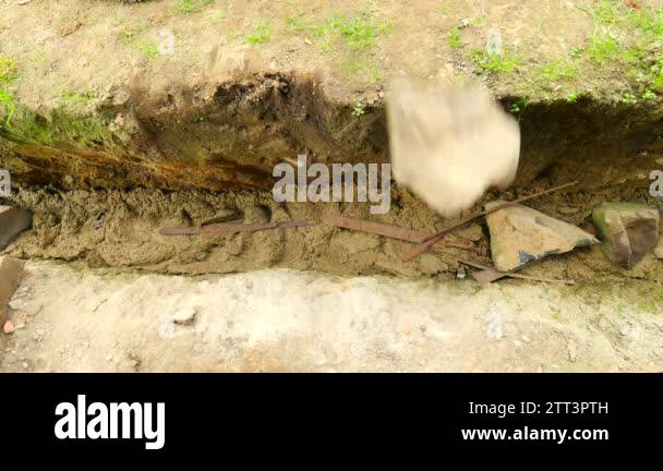 Pouring, laying concrete into foundations of the house using shovel of ...