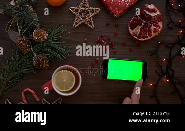 Top view man hand using mobile phone with green screen. Finger ...