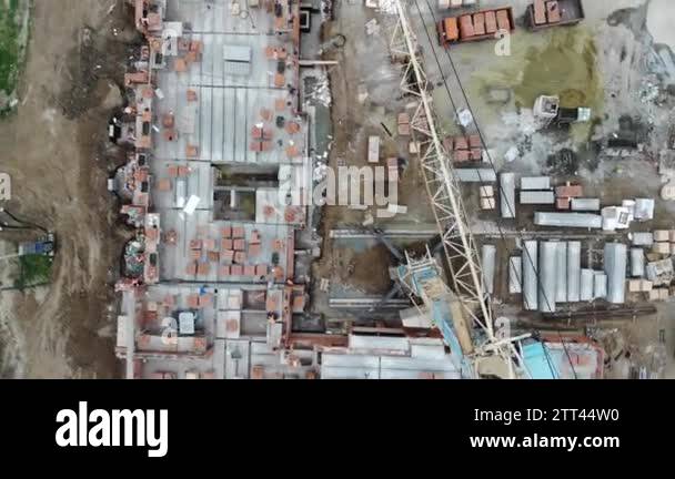 4k Birds eye view of building a house from scratch. Tower cranes ...