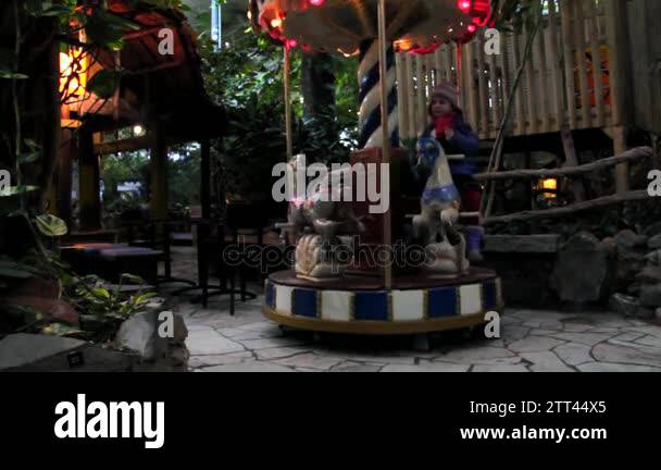 Little Blonde Girls at Carousel in the Beautifully Equipped Playground ...