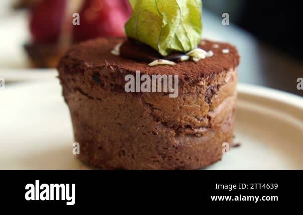 Close up texture lava dark chocolate cake with cape gooseberry topping ...