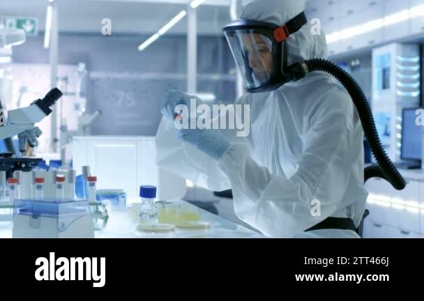 Medical Virology Research Scientist Works in a Hazmat Suit with Mask ...